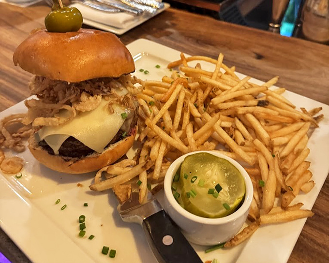 This isn't just a burger&mdash;it's architecture. Towering with toppings and flanked by golden shoestring fries that demand to be devoured.