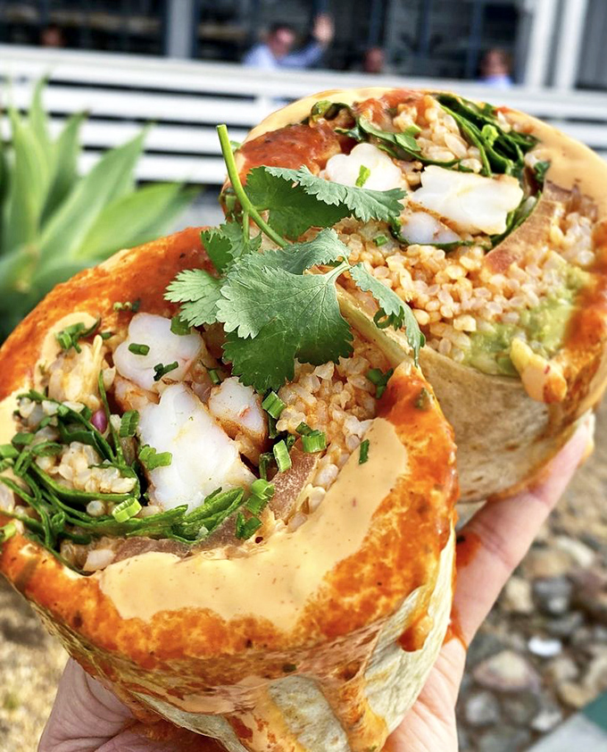 Not your abuela's burrito! This seafood-stuffed masterpiece marries coastal treasures with southwestern flair in a handheld vacation for your taste buds.