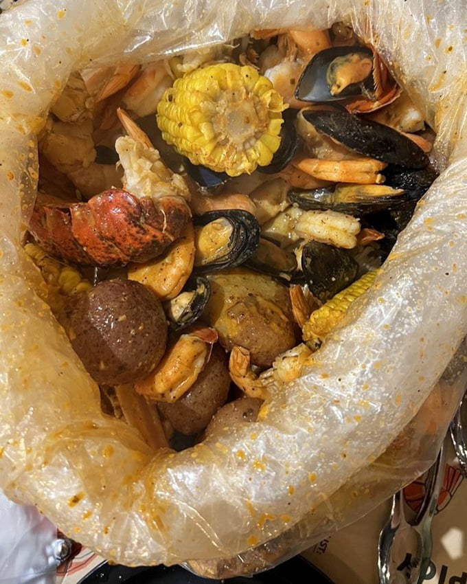 The plastic bag reveals its treasures like a pirate's chest &ndash; corn, potatoes, shellfish, and spices mingling in seafood harmony.
