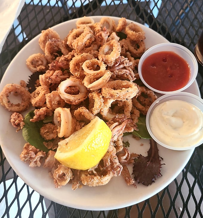 Calamari so perfectly fried it should have its own fan club. That squeeze of lemon is the culinary equivalent of a standing ovation.