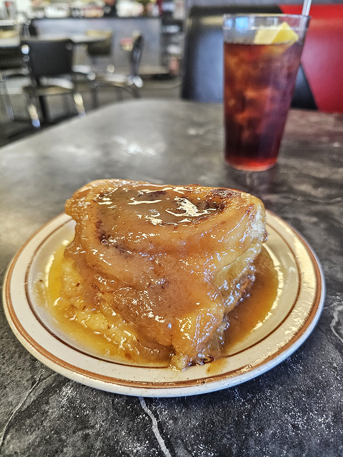 This isn't just a caramel roll—it's a sticky, gooey monument to morning indulgence that makes you forget you ever knew the word "calorie."
