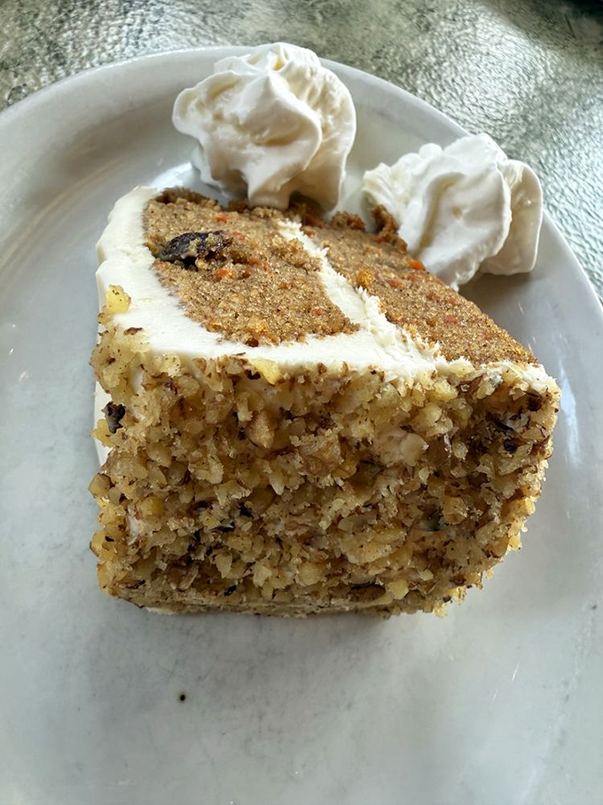 A slice of carrot cake that doesn't skimp on the good stuff&mdash;moist, dense, and crowned with cream cheese frosting dollops of pure joy.