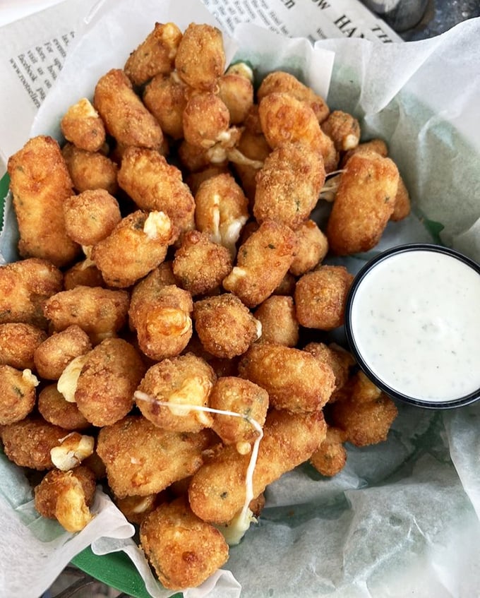These cheese curds don't just squeak—they practically sing a dairy aria, their golden-brown exteriors giving way to molten, stretchy centers.