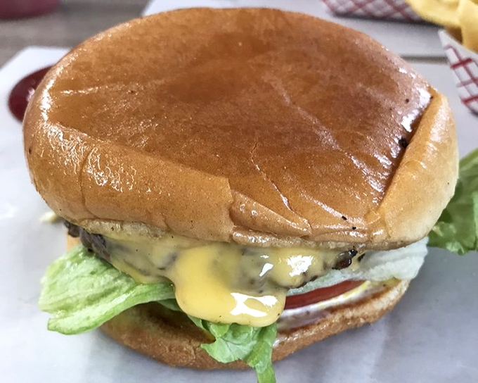Behold, the Johnson's cheeseburger in all its glory&mdash;where lettuce, tomato, and melted cheese meet a perfectly seasoned patty. Poetry on a bun.