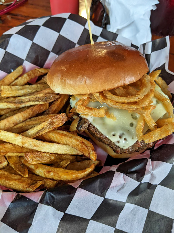 A proper burger should require both hands and several napkins. This beauty, with its melty cheese and crispy fries, demands nothing less.