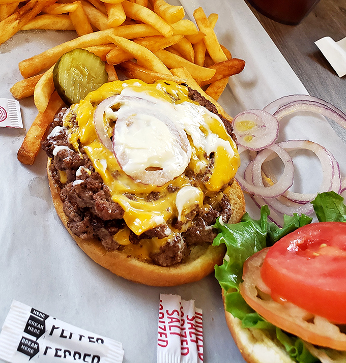 The burger that launched a thousand road trips. That melted cheese cascading down the sides isn't just decoration &ndash; it's edible artwork.