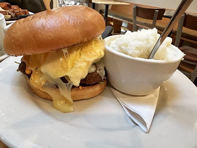 Not your average burger joint creation. This masterpiece sports a golden egg crown and comes with a side of comfort&mdash;creamy mashed potatoes that grandma would approve of.