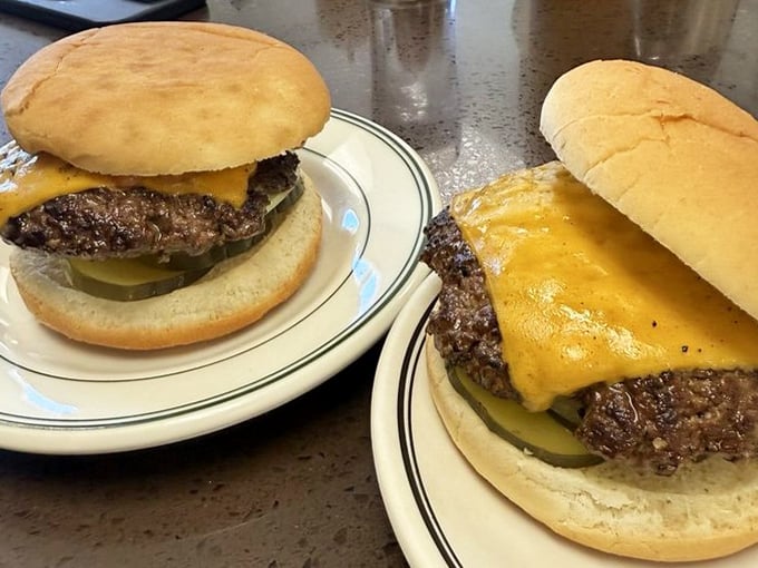 Two cheeseburgers, pickles peeking out like shy party guests. In a world of complicated food, this simplicity feels like coming home.