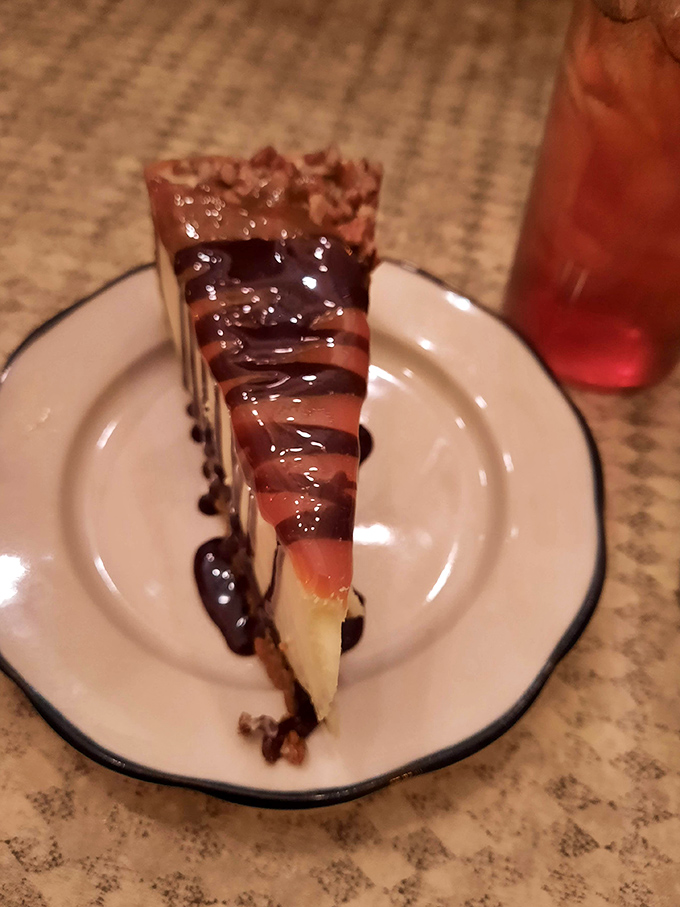 That slice of cheesecake isn't just dessert, it's therapy on a plate &ndash; layers of creamy decadence drizzled with what appears to be the tears of joyful angels.