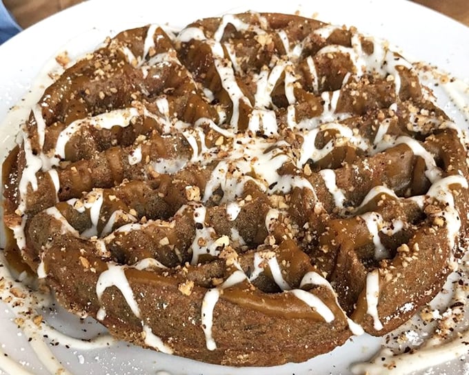 Dessert or breakfast? Why choose? This waffle wears its sweet toppings like jewelry, drizzled with sauce and dusted with what can only be described as happiness.