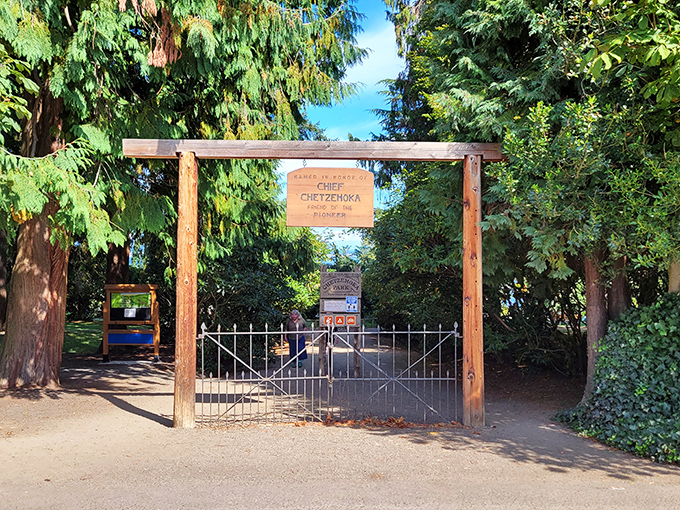 The entrance to Chetzemoka Park honors the S'Klallam chief while inviting visitors to discover gardens, picnic spots, and beach access beyond its rustic wooden gateway.