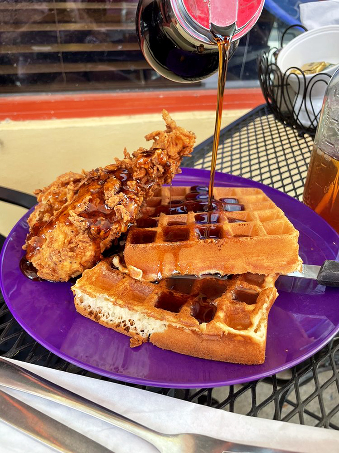 Chicken and waffles: the breakfast equivalent of finding out your favorite band is playing in your backyard. That syrup cascade is pure food theater.
