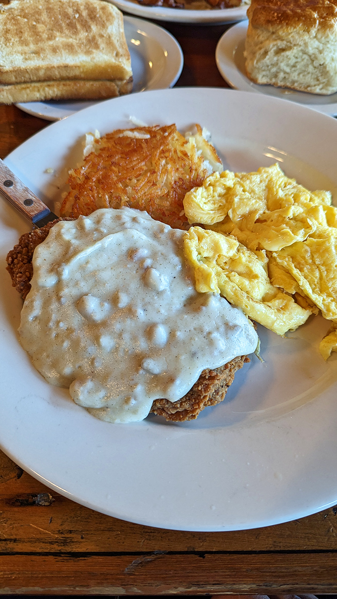Country gravy cascading over chicken fried steak like a delicious waterfall. This plate screams "comfort food" in the most eloquent way possible.