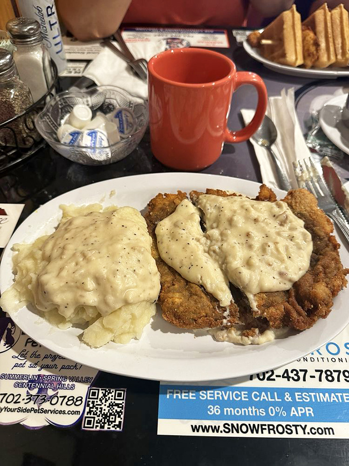 Chicken fried steak smothered in peppery country gravy alongside fluffy mashed potatoes&mdash;comfort food that hugs you from the inside out.