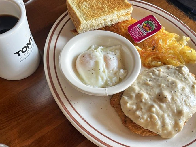 Chicken fried steak swimming in creamy gravy alongside eggs that look like they were collected this morning. This is the breakfast your cardiologist warned you about.