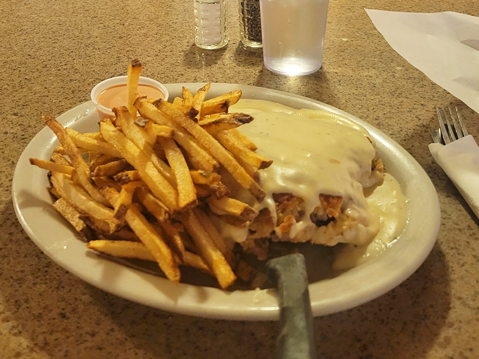 Chicken fried steak swimming in country gravy with golden fries standing at attention. Comfort food that hugs you from the inside.