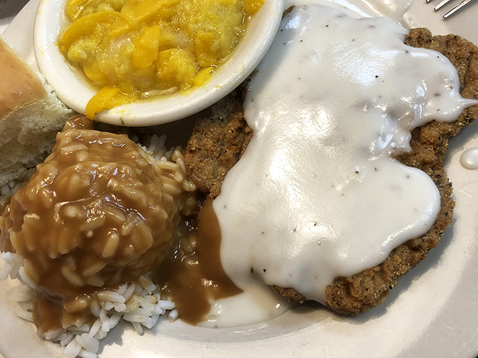 Country fried steak smothered in creamy gravy alongside squash casserole&mdash;the kind of plate that demands a post-meal nap.
