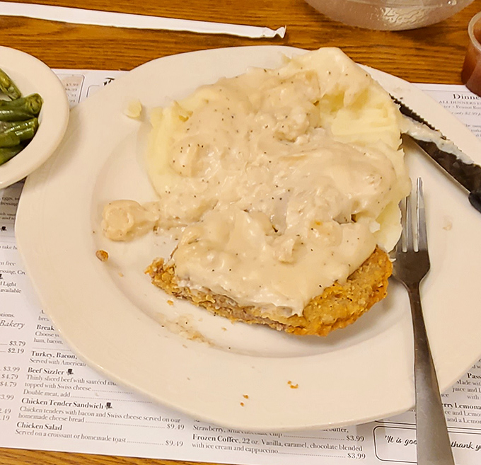 Chicken fried steak smothered in gravy: where comfort food meets art form and your diet plan waves the white flag.