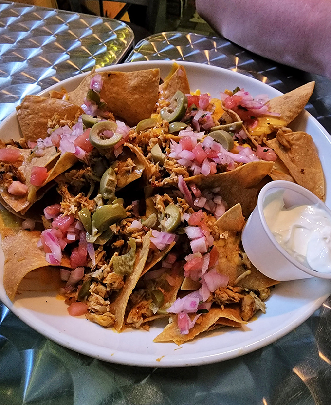 Nachos that don't know the meaning of "skimpy." Every chip is a treasure hunt of pulled pork, jalape&ntilde;os, and fresh toppings.