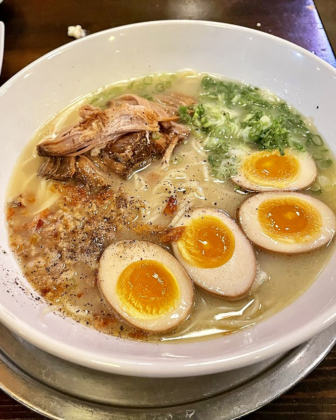 Ramen that makes you question every instant noodle you've ever eaten. Those soft-boiled eggs with their sunset-colored centers are pure poetry.