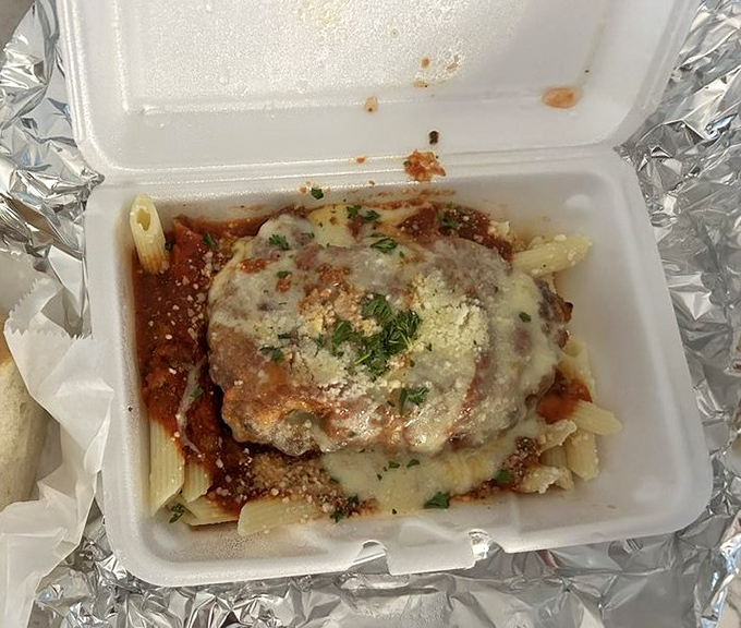 This isn't just chicken parmesan; it's a cheese-blanketed promise that some takeout meals can actually improve your day substantially.