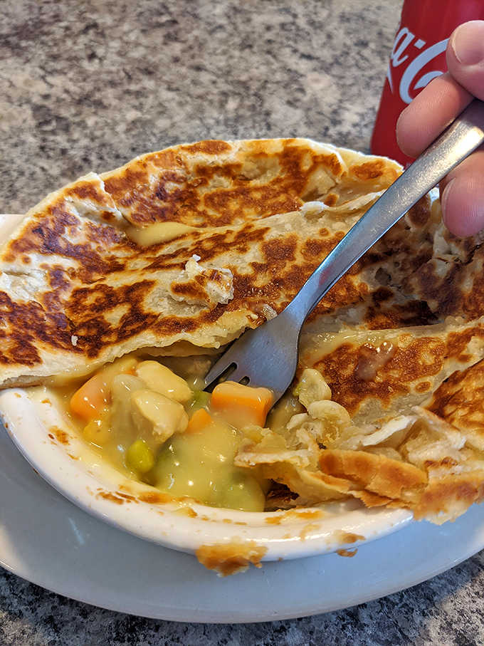 Beneath this golden, flaky crust lies a chicken pot pie so comforting it should come with its own therapist's license.