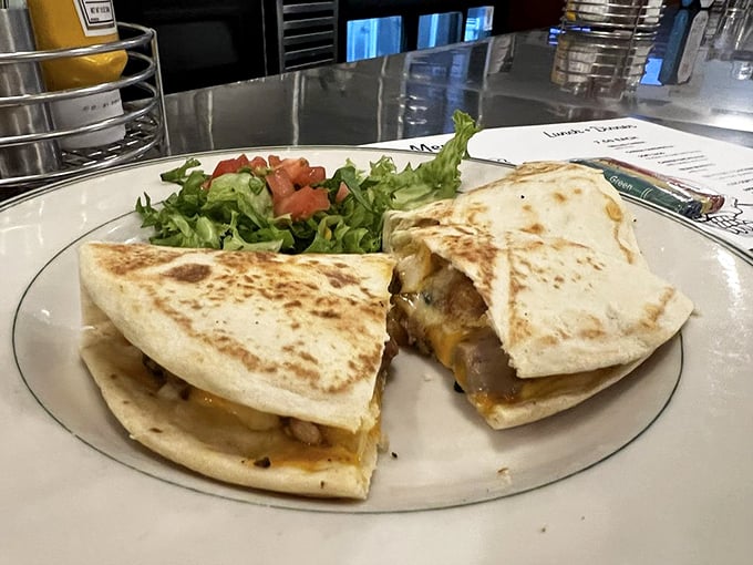 The quesadilla arrives like a golden-brown postcard from flavor country, cheese melting into every crevice, ready for its Instagram moment.