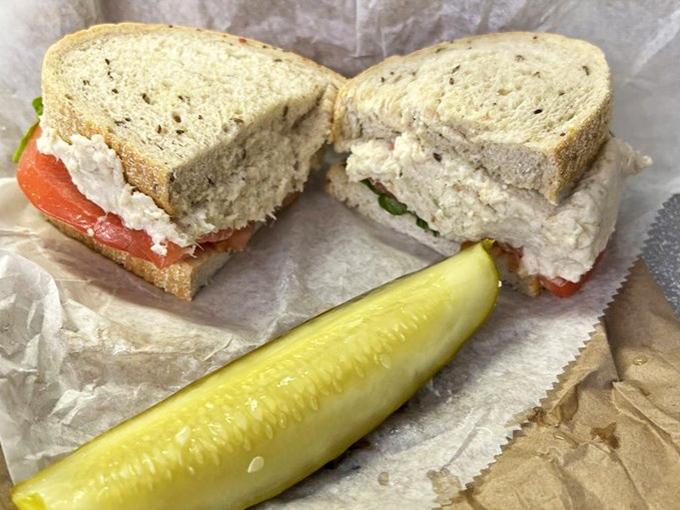 The chicken salad sandwich&mdash;where simplicity meets satisfaction, with a pickle standing guard against mundane lunches everywhere.