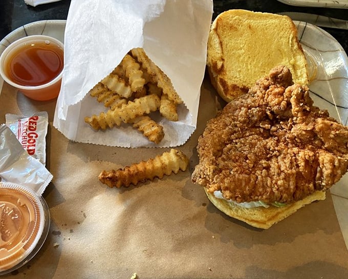 This isn't just a chicken sandwich; it's architecture. Golden-brown fortress walls protecting a juicy interior, with crinkle-cut fries standing guard nearby.