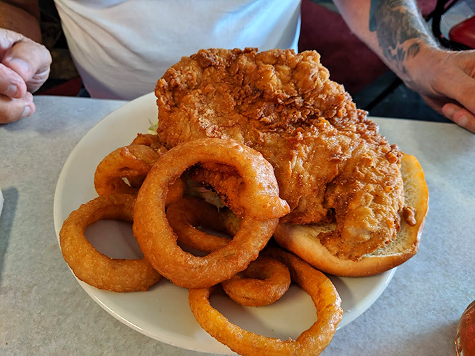 Crispy meets juicy in this chicken sandwich masterpiece. Paired with those legendary onion rings, it's comfort food that speaks a universal language.