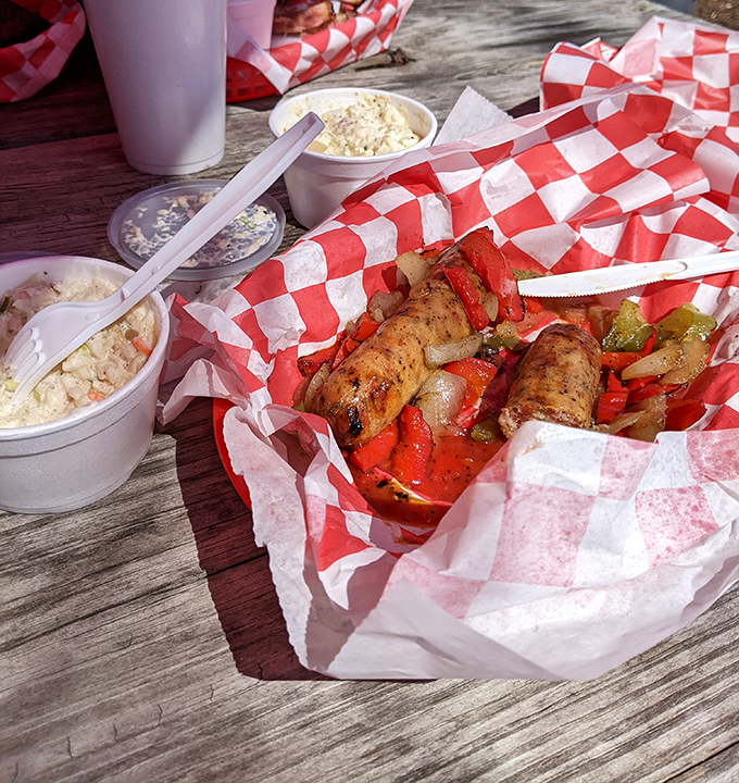 Grilled sausages nestled among peppers and onions&mdash;proof that sometimes the simple things in life truly are the most magnificent.