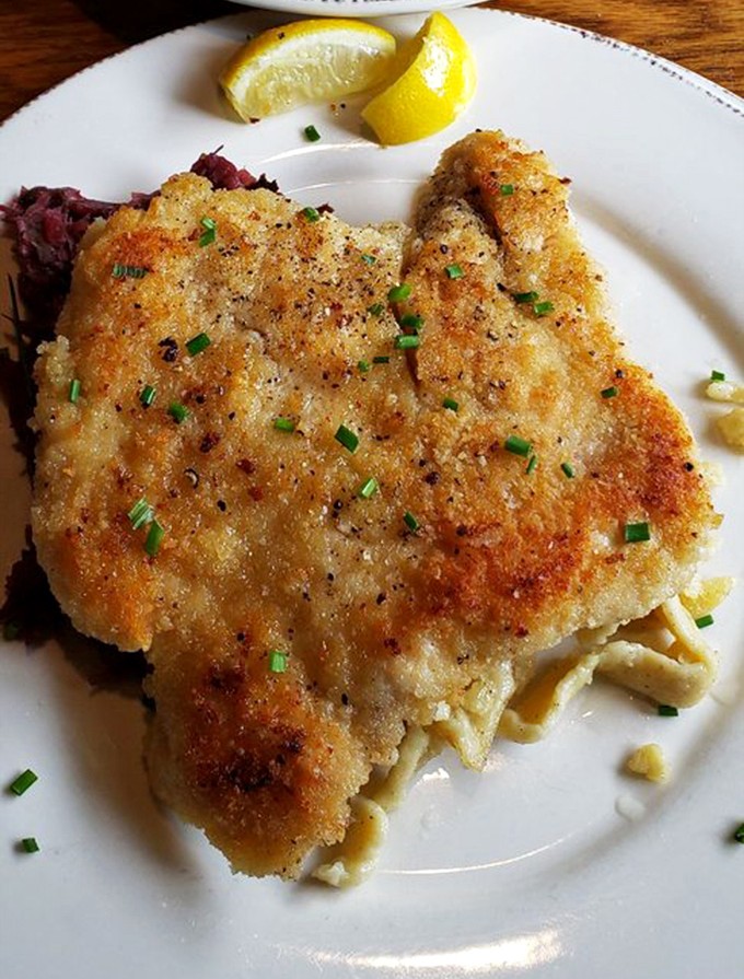 The star of the show&mdash;chicken schnitzel with its golden-brown crust that shatters with each bite. That lemon wedge isn't just garnish; it's essential equipment.