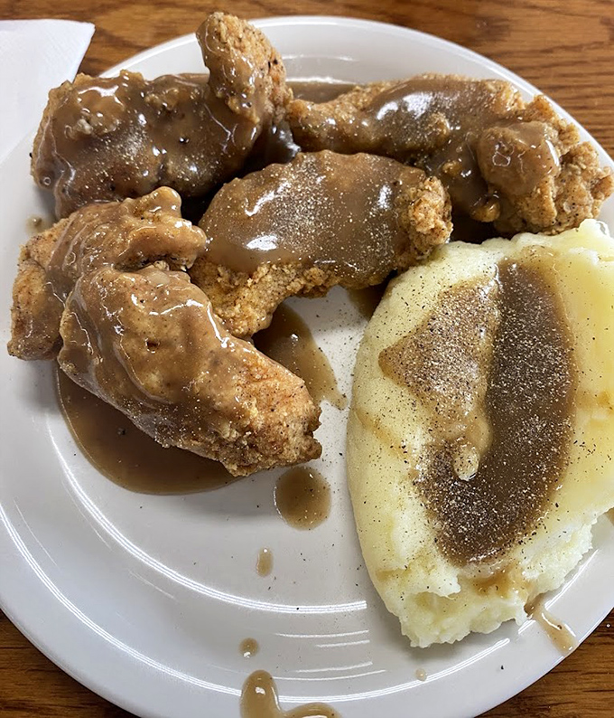 Fried chicken and mashed potatoes swimming in gravy&mdash;the kind of plate that makes you want to hug the cook and take a nap simultaneously.