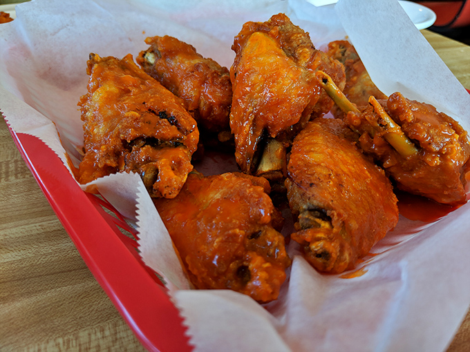 Wings so perfectly sauced they should come with a warning label: "May cause involuntary food noises that embarrass your dining companions."