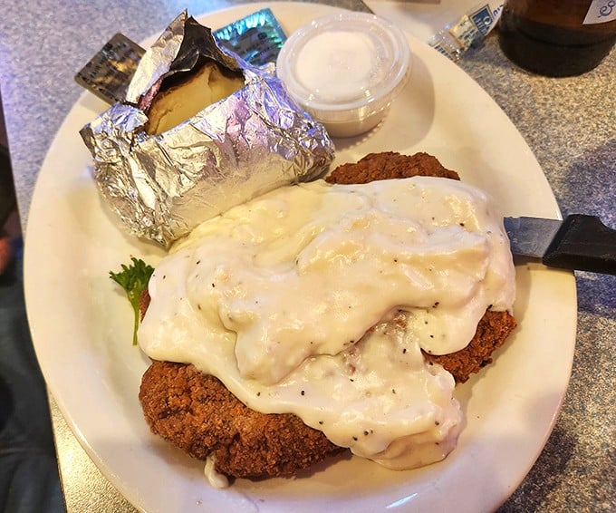 Country-fried steak smothered in creamy gravy—because some mornings require more than just coffee to face the day.