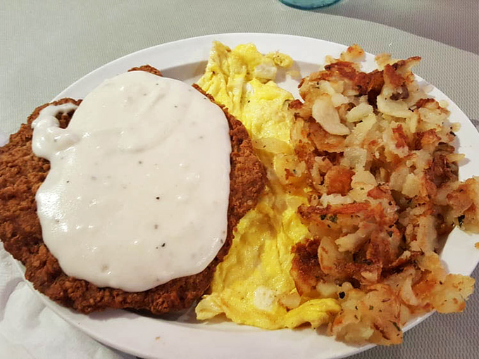 Country fried steak that could make a vegetarian reconsider life choices, with gravy that should be classified as a controlled substance.