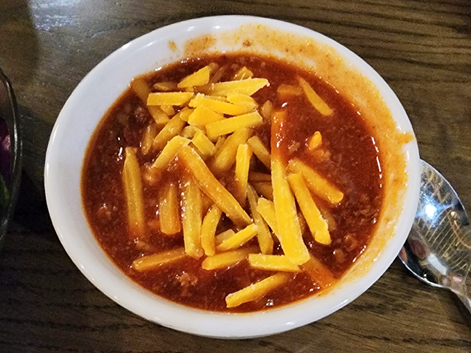 A hearty bowl of chili topped with melted cheese that stretches with each spoonful. Winter comfort in summer, fall, and spring too.