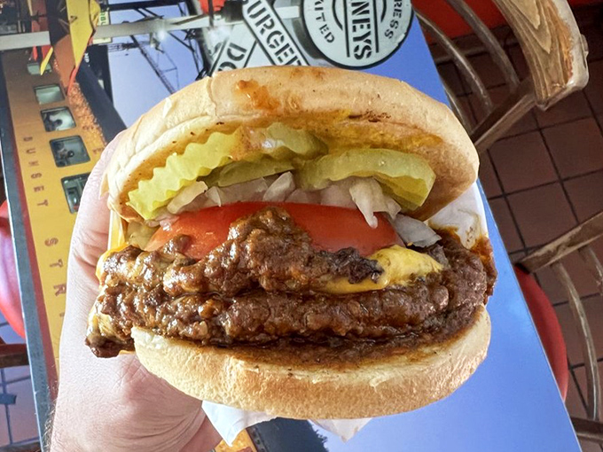 Architecture of deliciousness: fresh bun, juicy patty, legendary chili, and crisp toppings stacked with the precision of a Hollywood set designer.