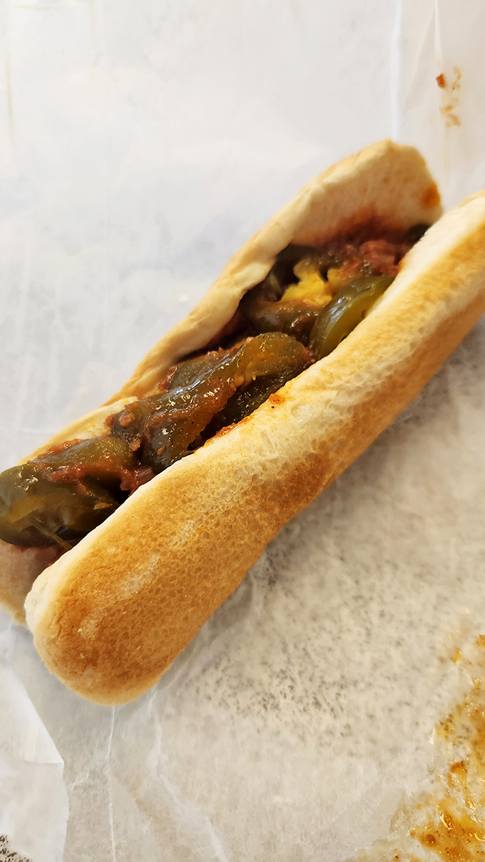 The Chili Dog arrives like a savory lullaby&mdash;tender onions nestled alongside the hot dog in a soft bun that cradles the whole beautiful mess.