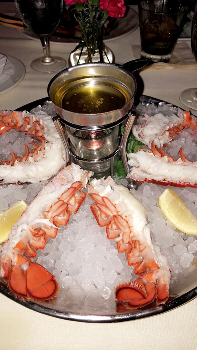 Ocean royalty on ice—these lobster tails aren't just served; they're presented like the treasures they are, complete with golden dipping sauce.