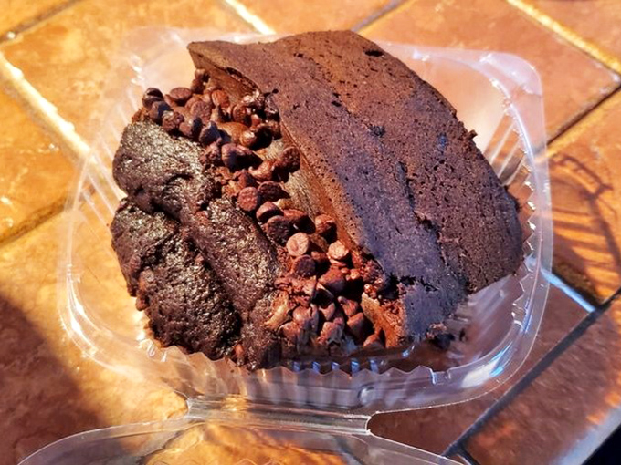Chocolate cake so rich it probably has its own accountant. Those cocoa nibs aren't garnish—they're exclamation points at the end of a delicious sentence.