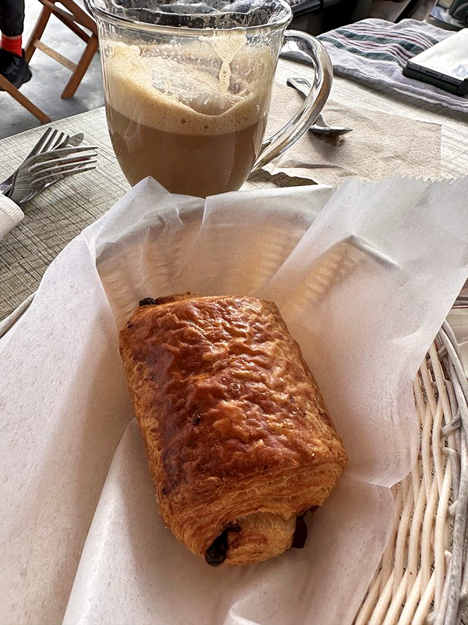 A chocolate croissant and caf&eacute; au lait&mdash;the breakfast combo that makes Monday mornings bearable. That golden exterior promises buttery layers within.