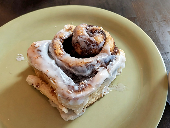 This cinnamon roll isn't just baked &ndash; it's architected, with layers spiraling toward a center that's practically begging for your fork's attention.