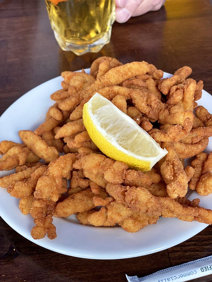 A mountain of perfectly fried clam strips with that essential squeeze of lemon. Simple pleasures that remind you why classics became classics in the first place.