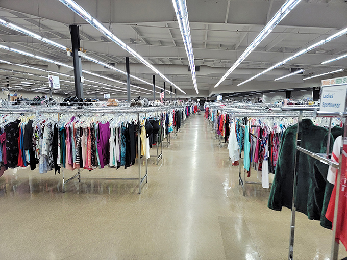 The clothing section stretches toward the horizon like a textile sea, each rack a different island of possibility.
