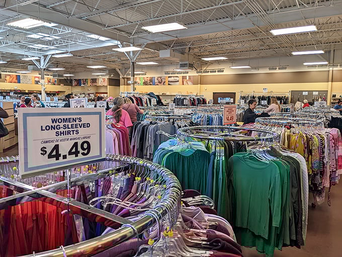 A rainbow of possibilities hangs in neat rows, each garment waiting for its second chance at fashion greatness.