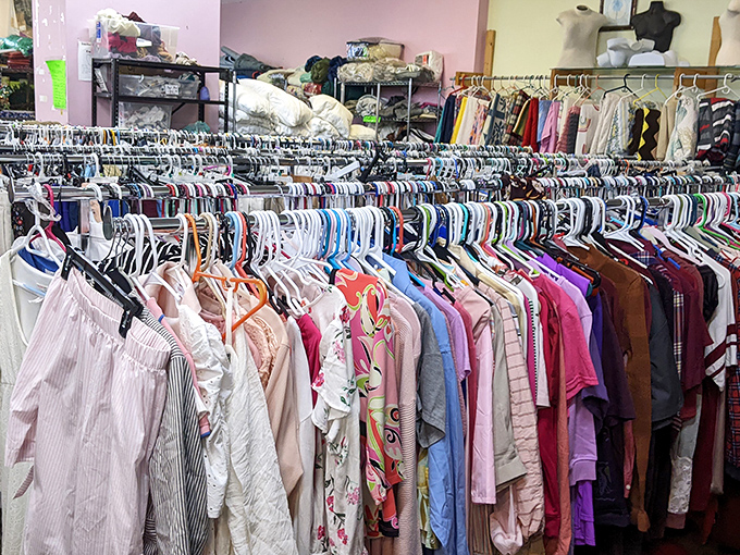 The clothing section stretches into infinity, a textile rainbow where vintage treasures hide among everyday basics like diamonds in denim.