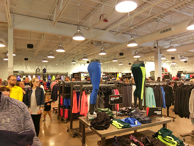 Inside Under Armour, athletic wear becomes art. The wall of sneakers resembles a museum installation dedicated to the religion of sports and comfort.