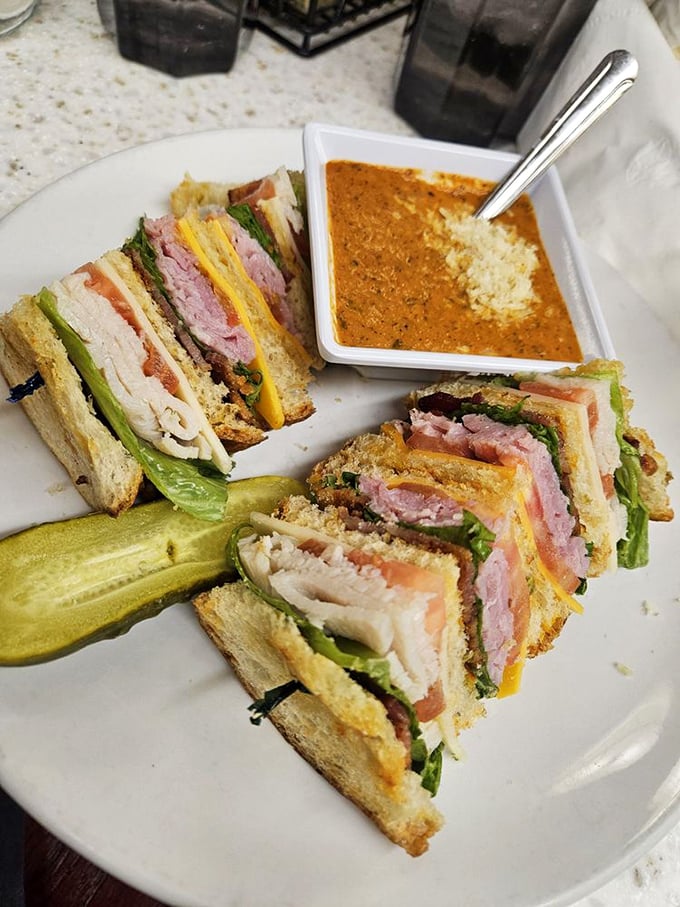 This club sandwich isn't playing around. Triple-decker architecture with a side of soup that's practically demanding to be dunked into.