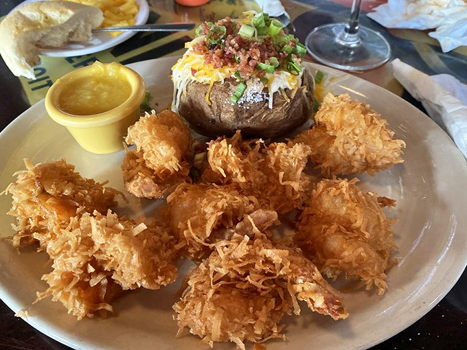 Golden-fried coconut shrimp that crunch like walking on autumn leaves. The loaded baked potato isn't just a side&mdash;it's a co-star.